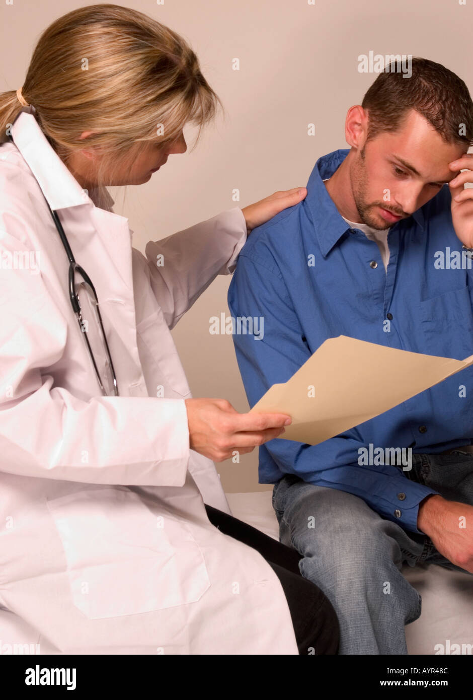 Female GP gives male patient bad report Stock Photo - Alamy