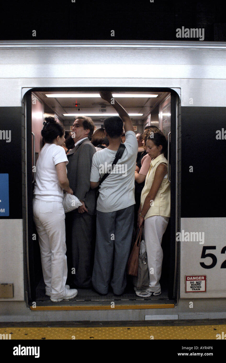 Passengers crowd into commuter train in Penn Station in New York Stock ...