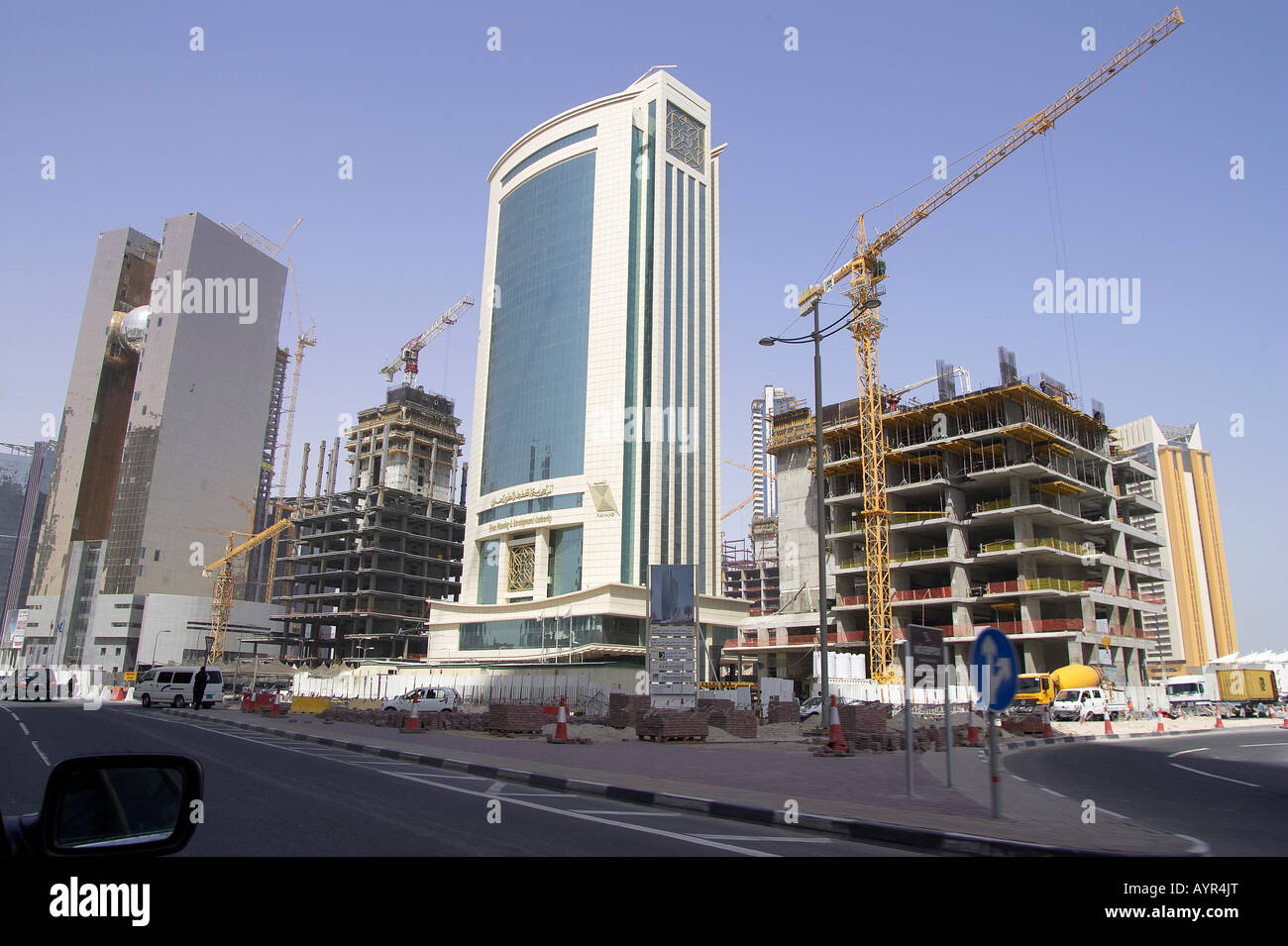Skyscraper between two construction sites in Doha, Qatar Stock Photo ...