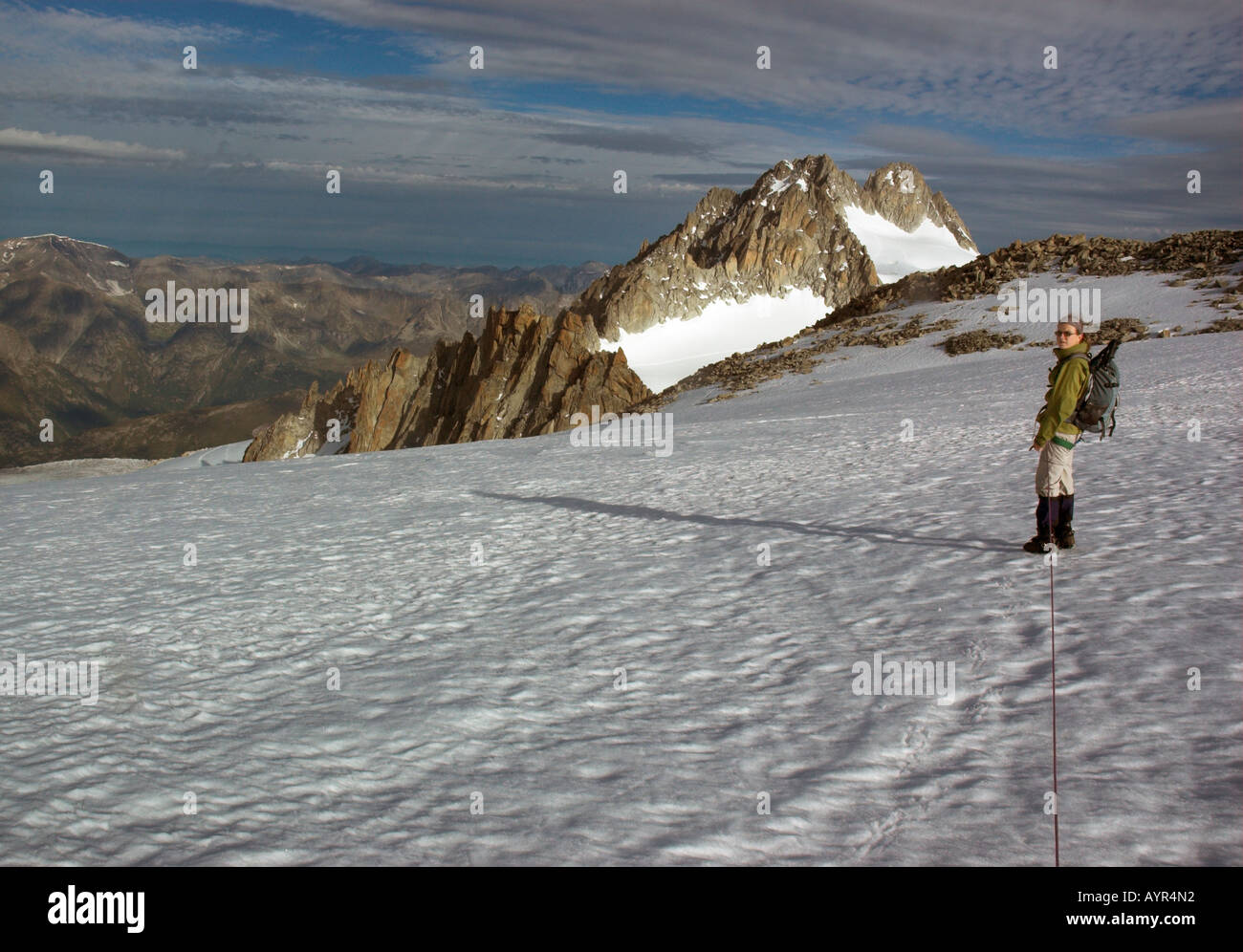 A lone female climber pauses to take in the view high in the French ...