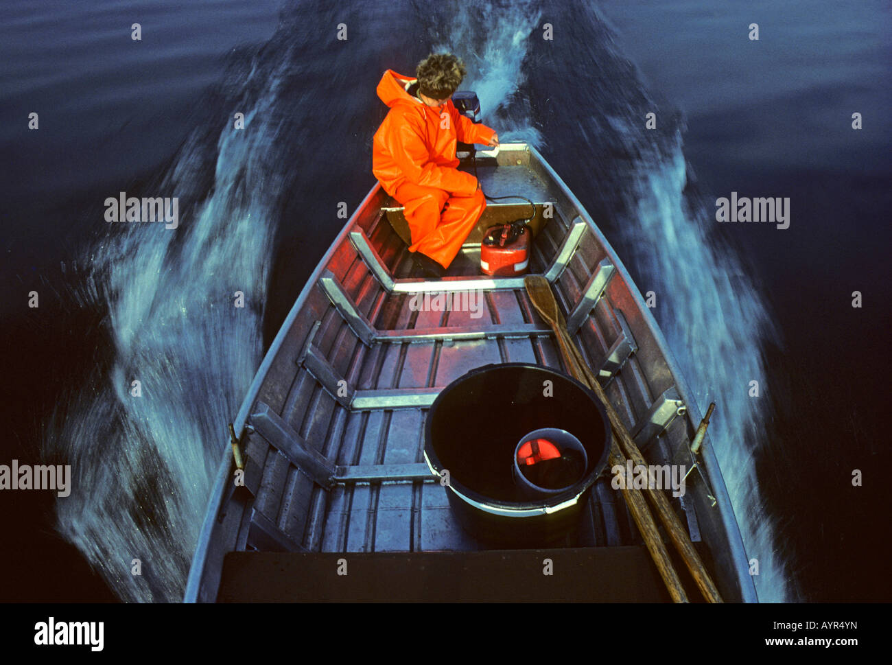 Fisherman in an aluminum rowboat with outboard engine on the Ammersee ...