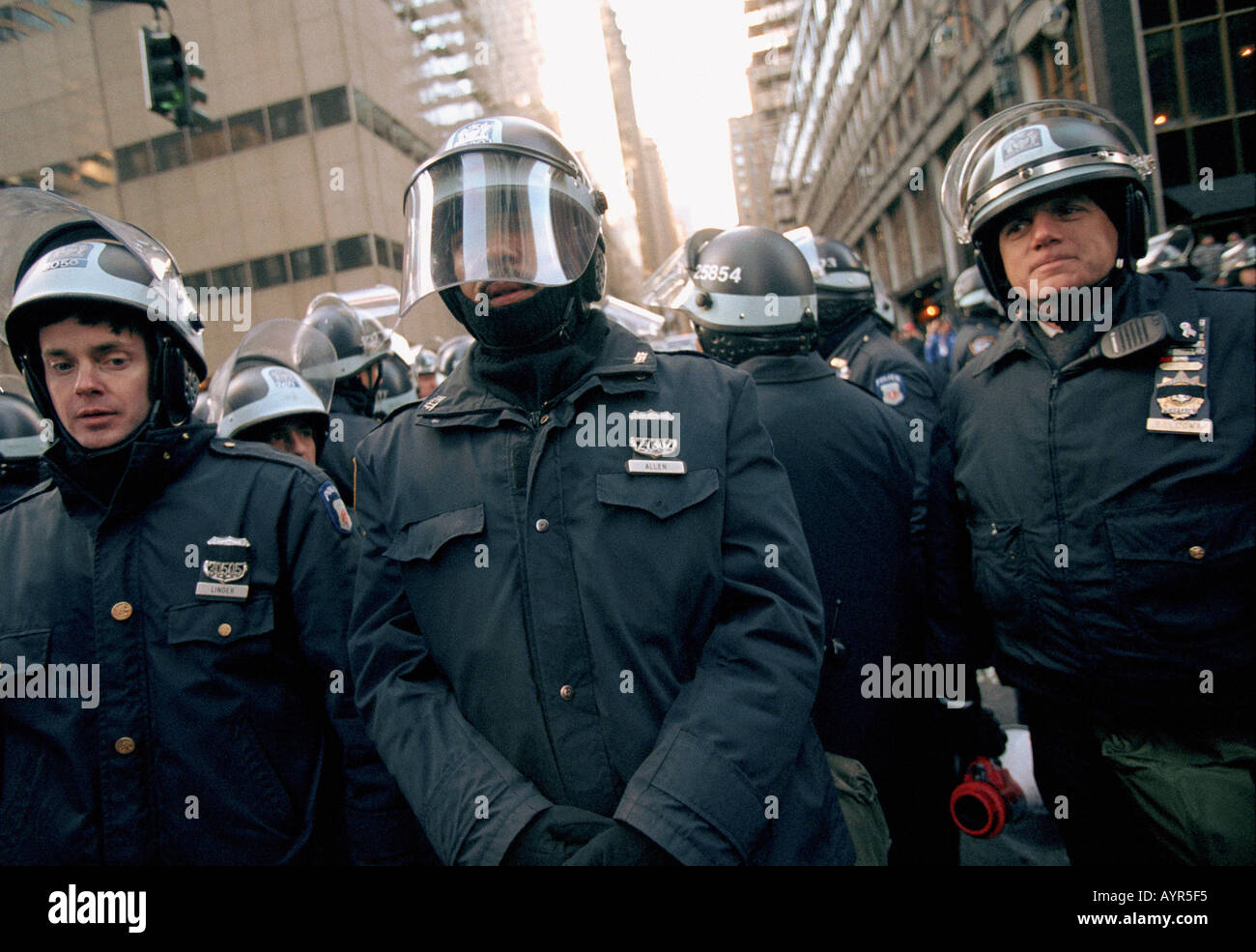 NYPD officers stand guard during a march against the World Economic ...