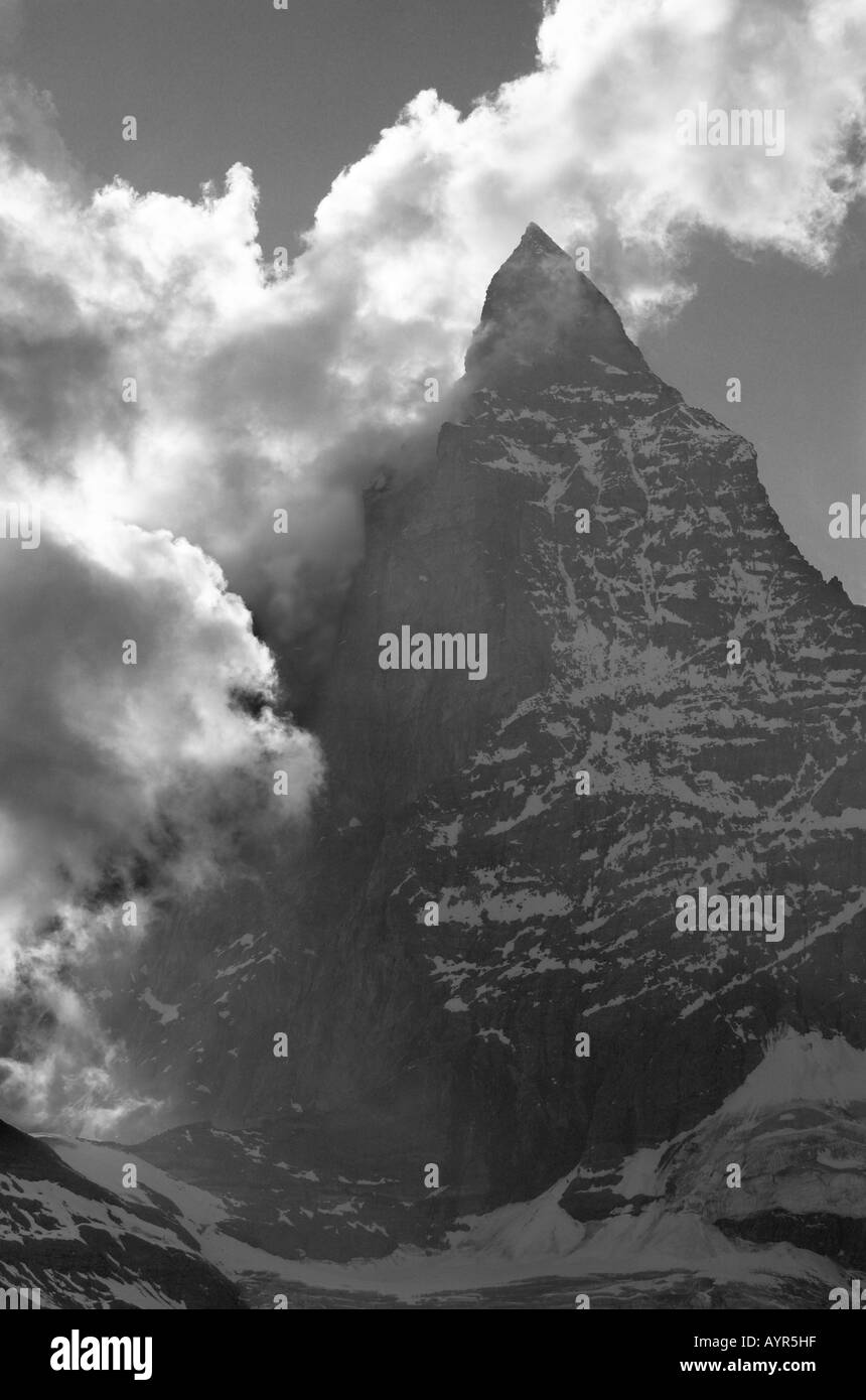 Afternoon clouds gather round the huge east face of the Matterhorn in ...