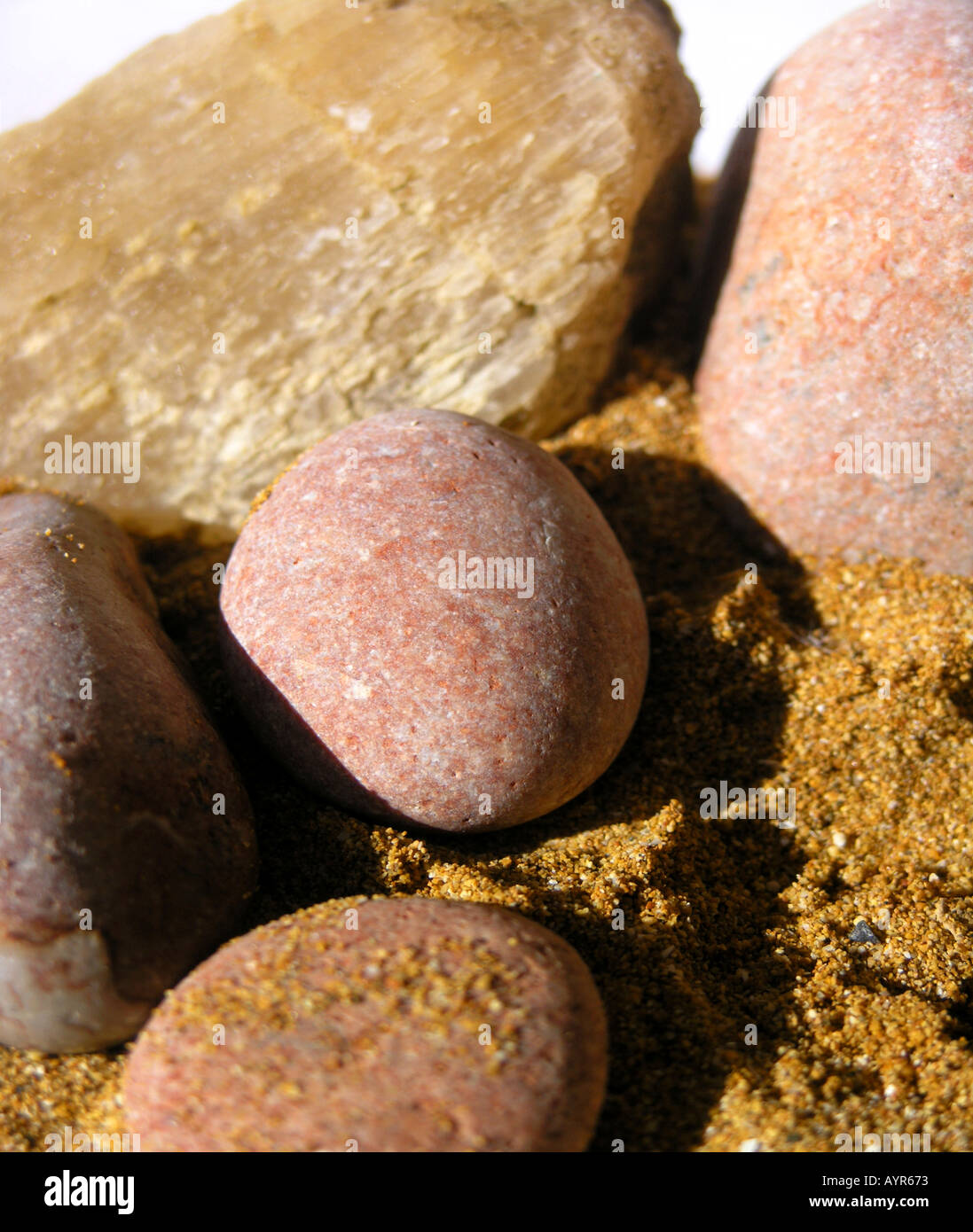 Pink pebbles on sand Stock Photo - Alamy