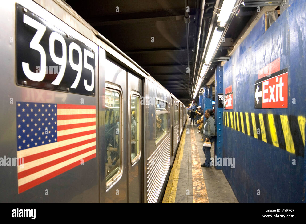TRAIN WITH US FLAG IN RUNDOWN SUBWAY PLATFORM IN MANHATTAN NEW YORK ...