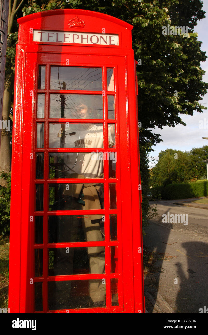 Man inside British red telephone box Stock Photo - Alamy