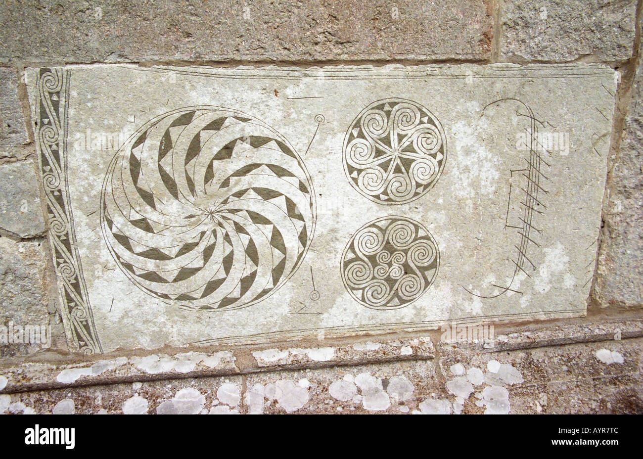 Ancient engraved rock built into a wall of church building at Bro ...
