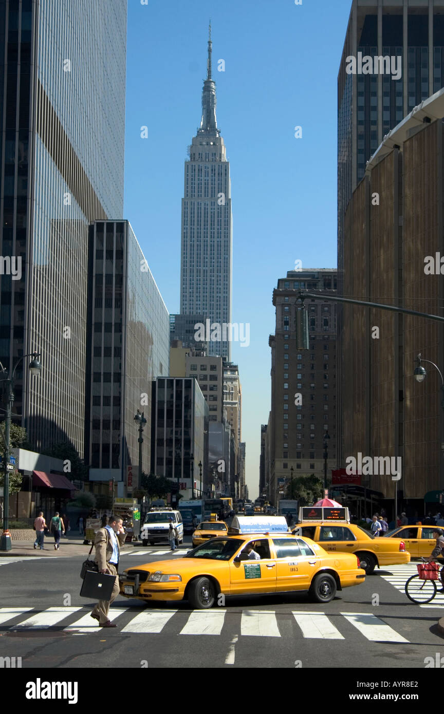 YELLOW TAXI CAB WAITING AT PEDESTRIAN CROSSING WITH VIEW TO EMPIRE ...