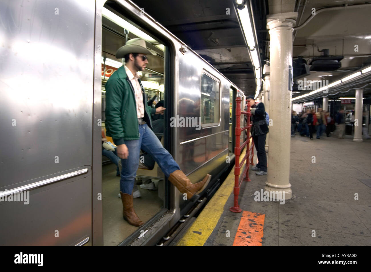 MANHATTAN CITY COWBOY GETTING OFF SUBWAY TRAIN AT TIMES SQUARE NEW YORK ...
