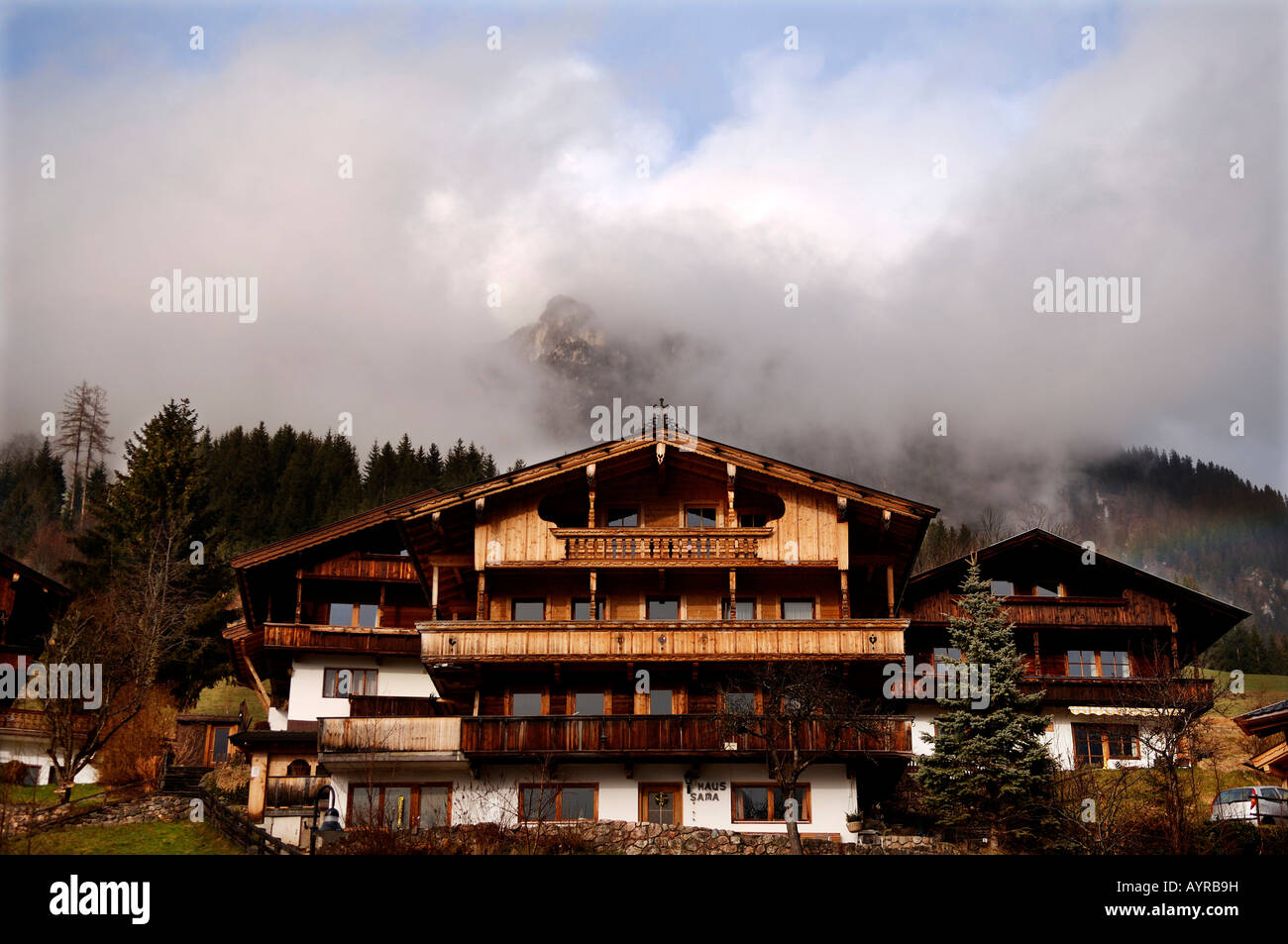 Tirolean farmhouse in front of mountains, fog, Alpbach, Tirol, Austria ...