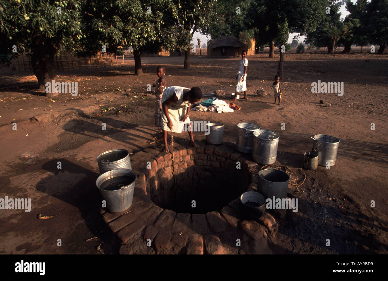 People gathering water at well in Malawi village Stock Photo - Alamy