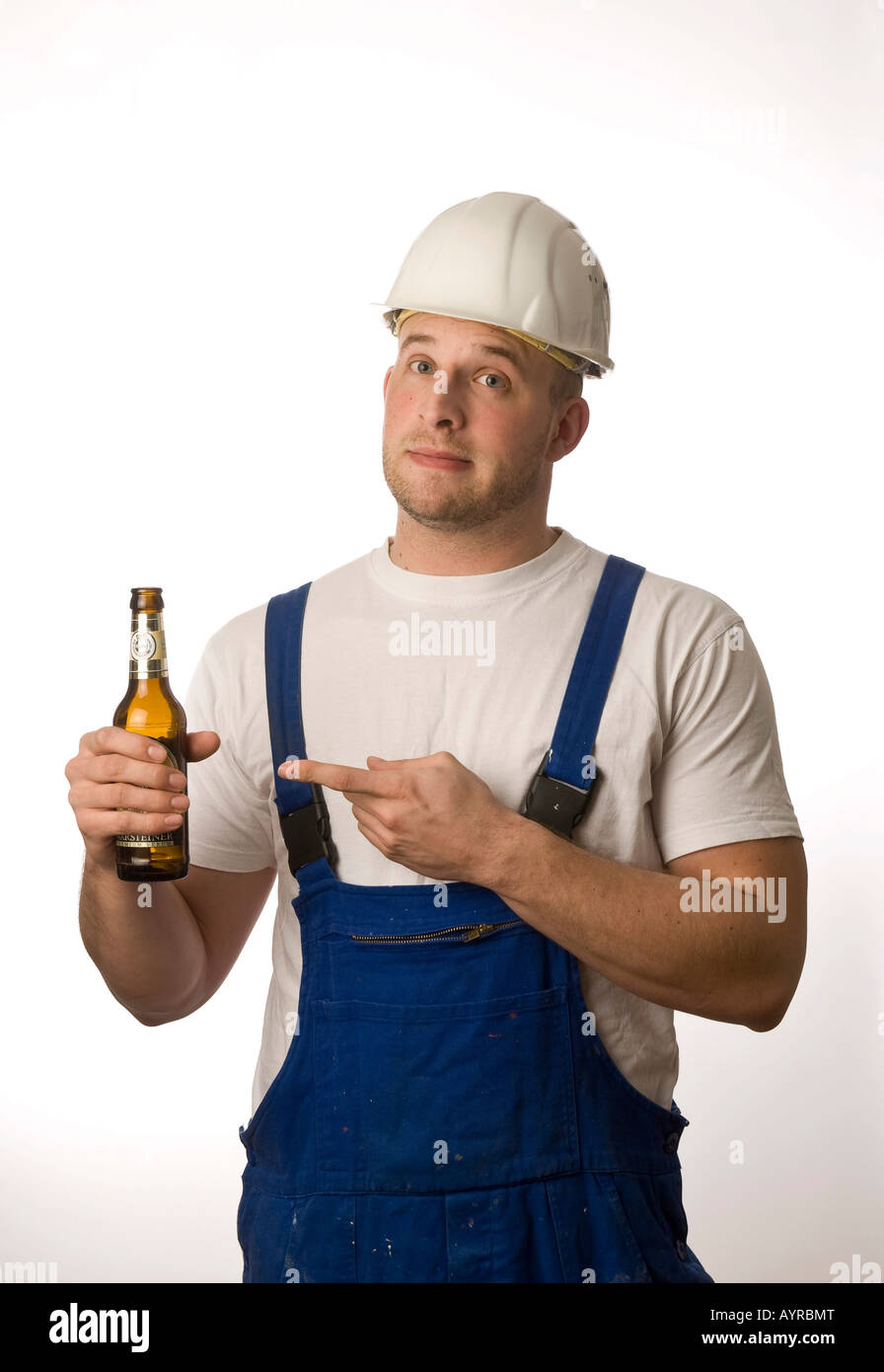 Construction worker holding a bottle of beer Stock Photo - Alamy