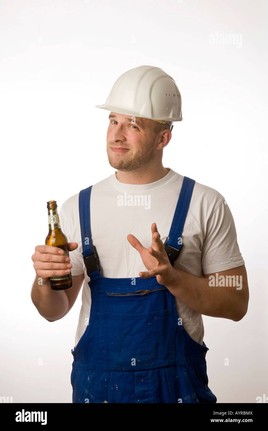 Construction worker holding a bottle of beer Stock Photo - Alamy