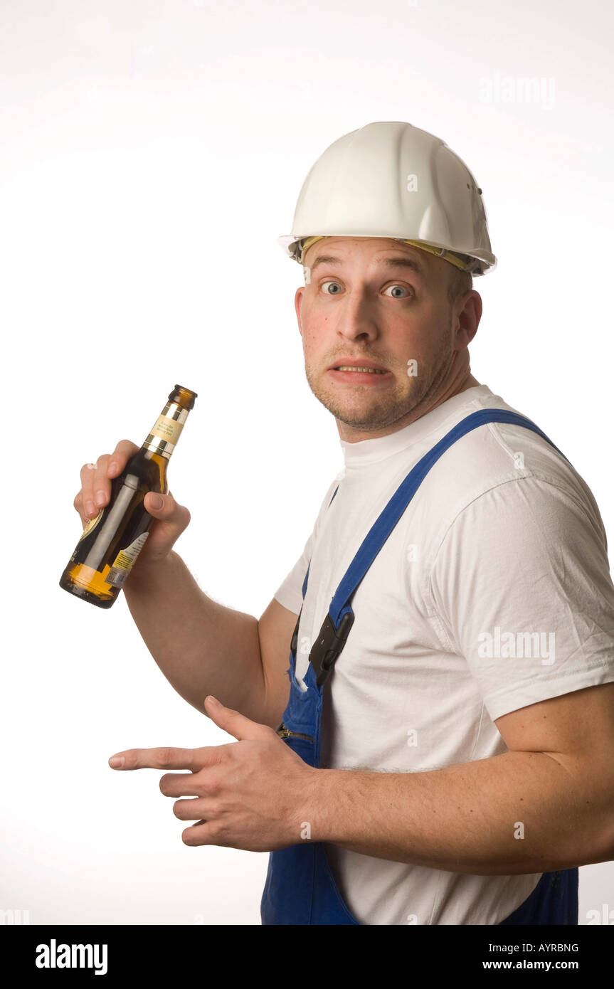 Construction worker holding a bottle of beer Stock Photo - Alamy