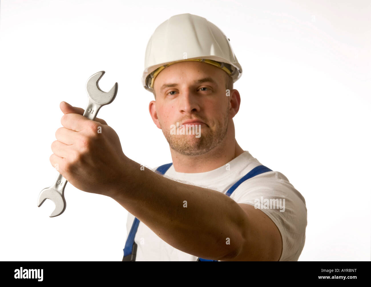 Construction worker holding open-end wrench Stock Photo - Alamy