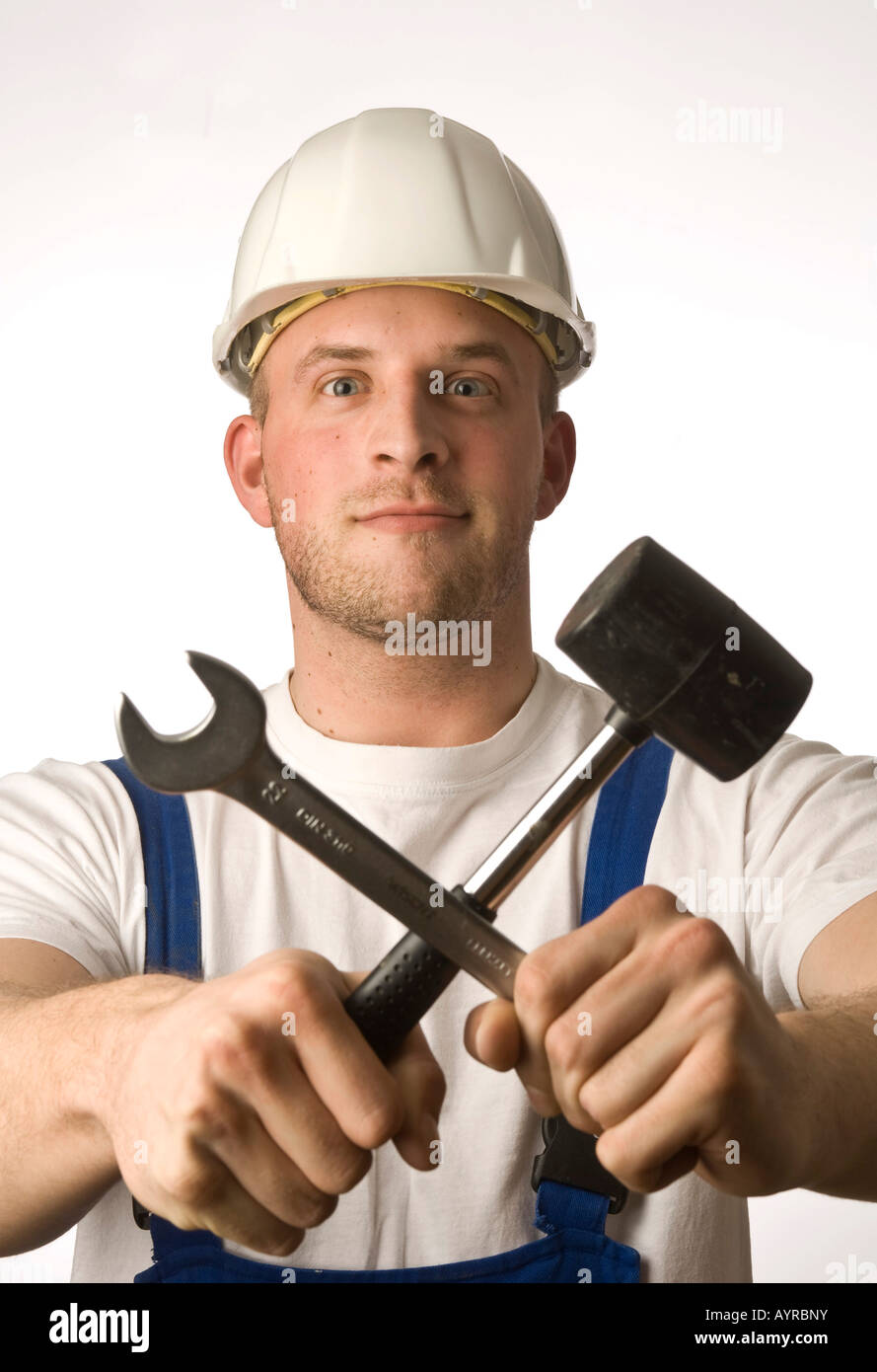 Construction worker holding tools, open-end wrench and hammer Stock ...