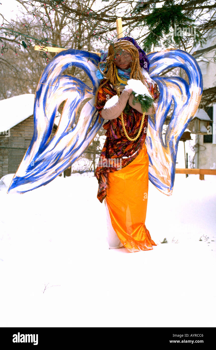 Guardian angel standing in the snow in front yard. Minneapolis ...