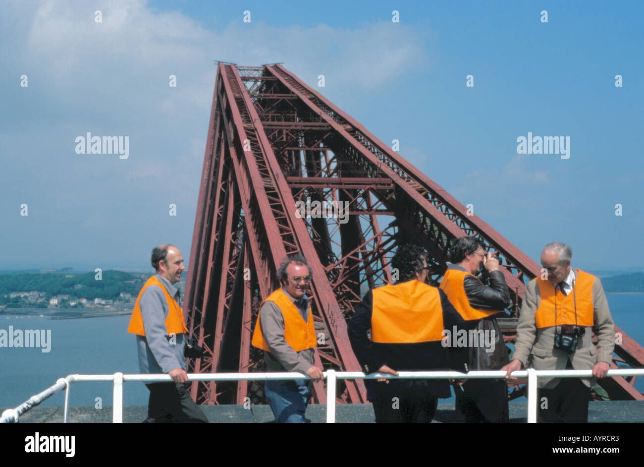 Visitors on the Forth Rail Bridge wearing safety vests, Firth of Forth ...