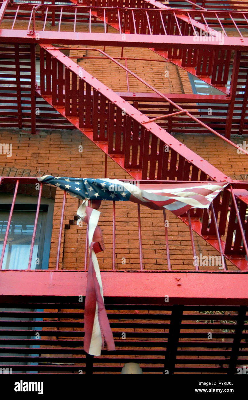 BROKEN US FLAG HANGING ON FIRE ESCAPE LOWER EAST MANHATTAN NEW YORK ...