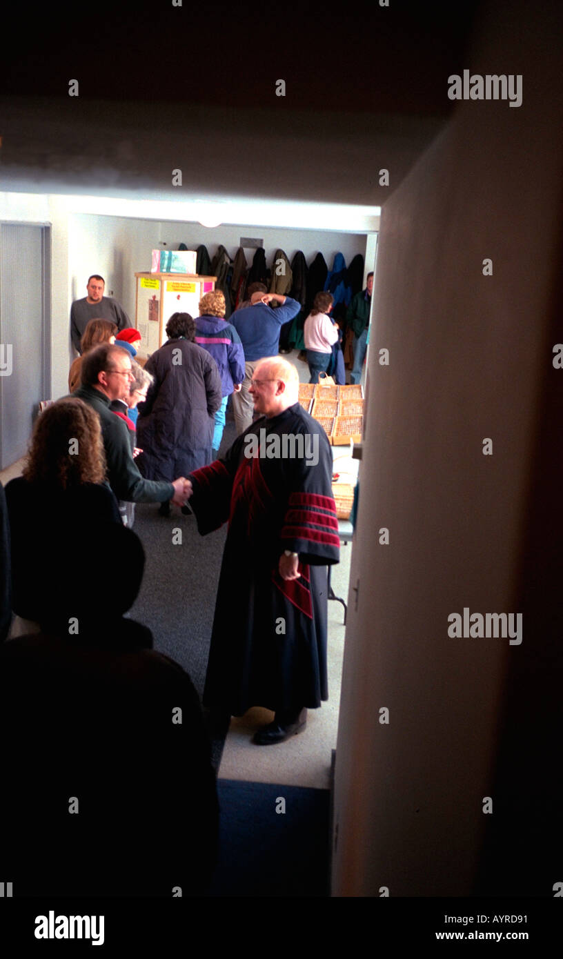 Minister shaking hands with man ages 60 after church service. St Paul ...