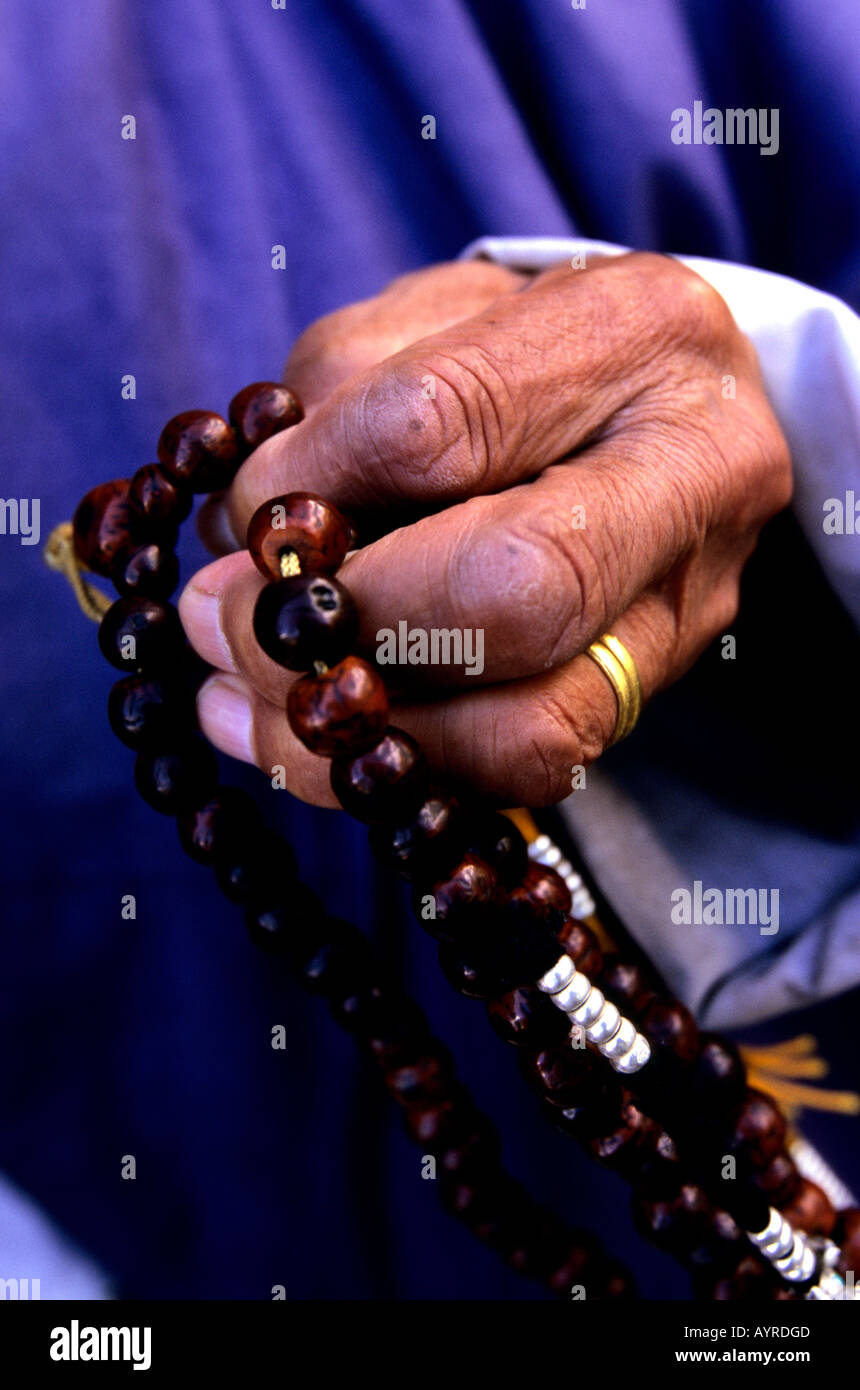 Detail of a man's hand holding a rosary, Bhutan Stock Photo - Alamy