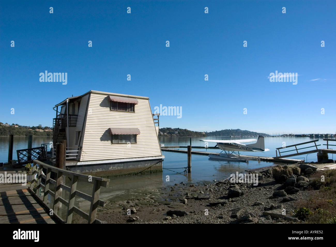 WOODEN HOUSE BOAT WITH HARBORED SEAPLANE IN THE SAUSALITO AREA MARIN ...