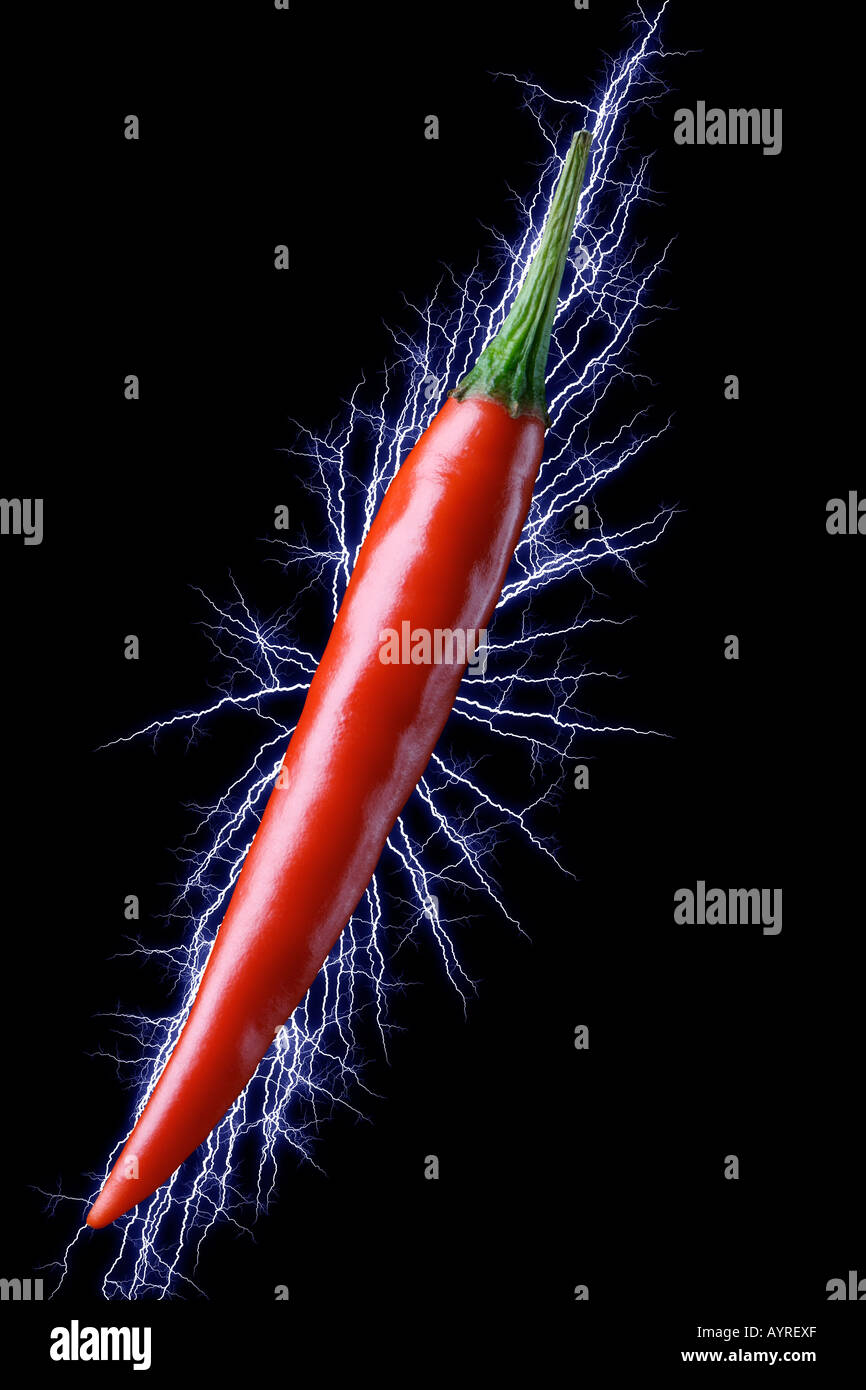 Hot bright red chilli pepper shown with electrical sparks in background ...