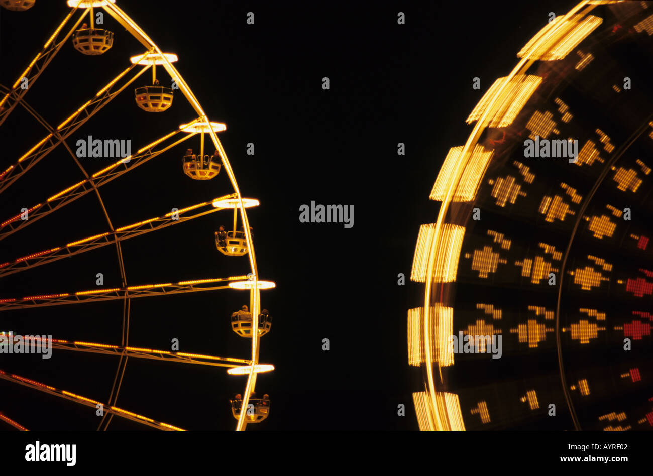 Ferris wheels one moving one stationary Stock Photo - Alamy