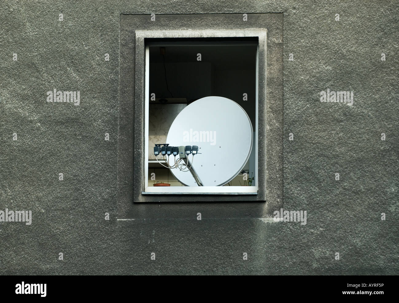 satellite dish with five LNBs in the open window of a residential ...