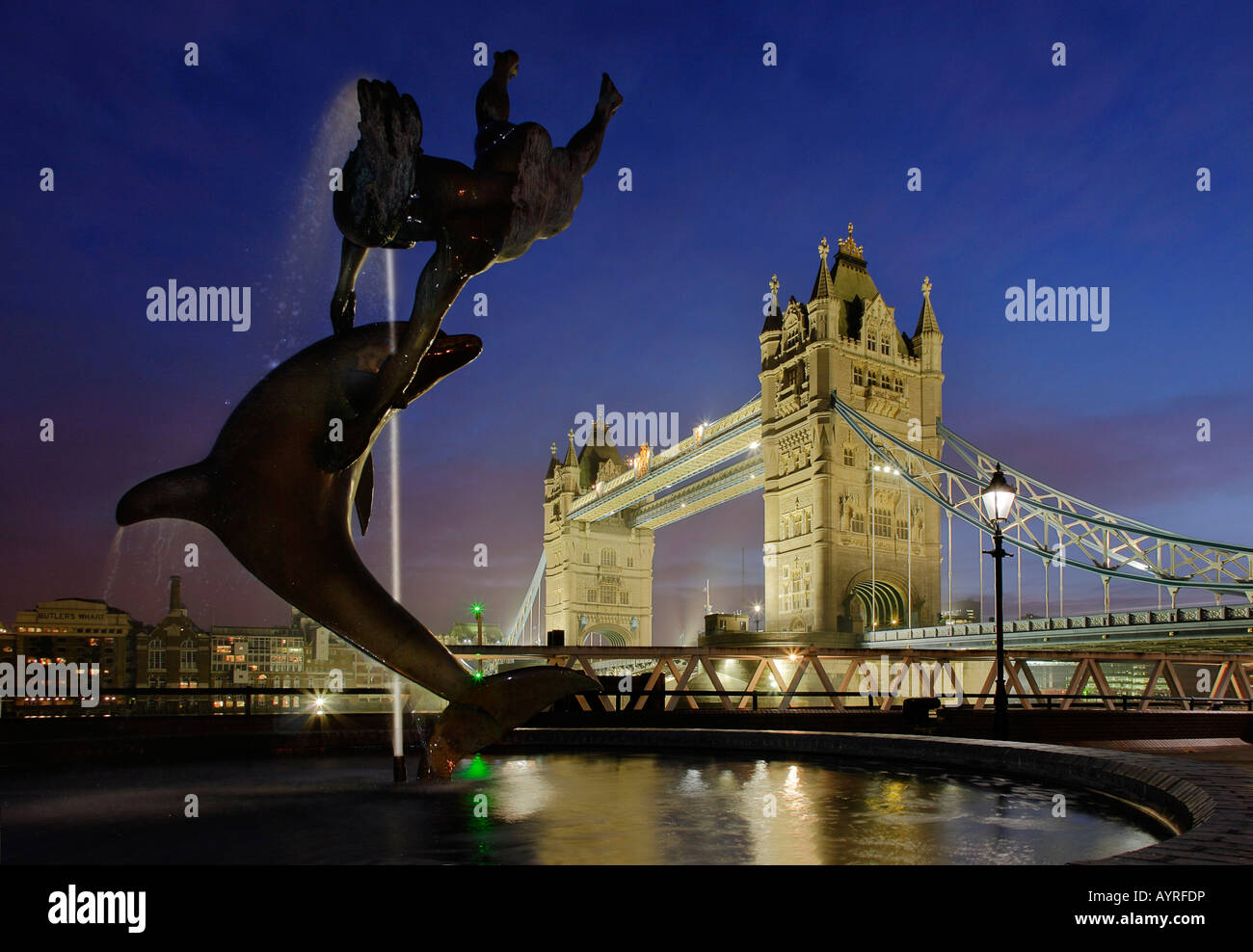 Dolphin statue in front of Tower Bridge at dusk, London, England, UK ...