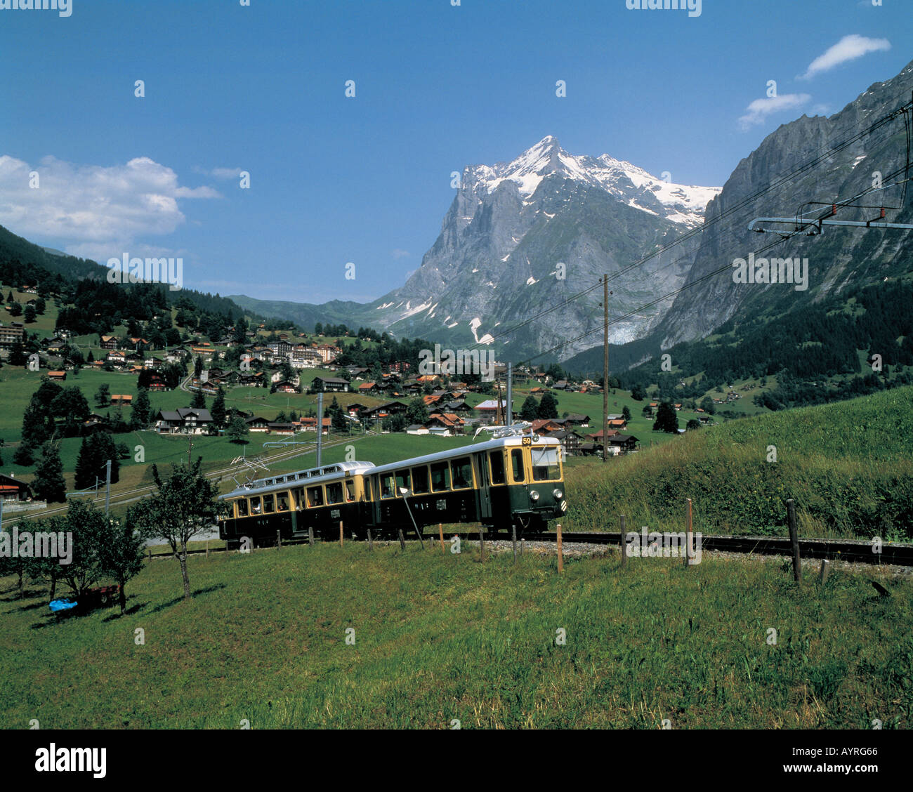 Train in Mountains with Town Stock Photo - Alamy