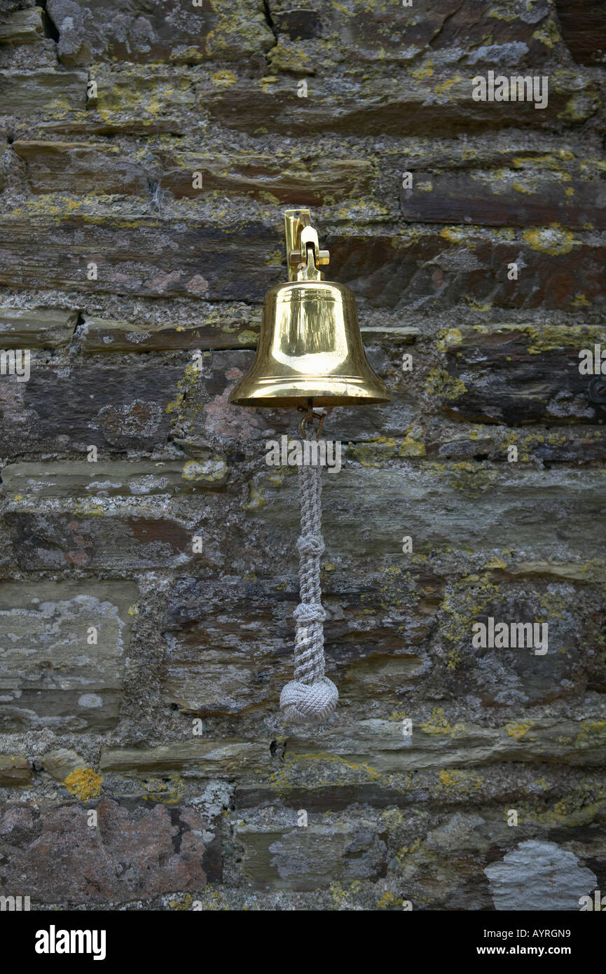 Golden bell on stone wall Stock Photo - Alamy