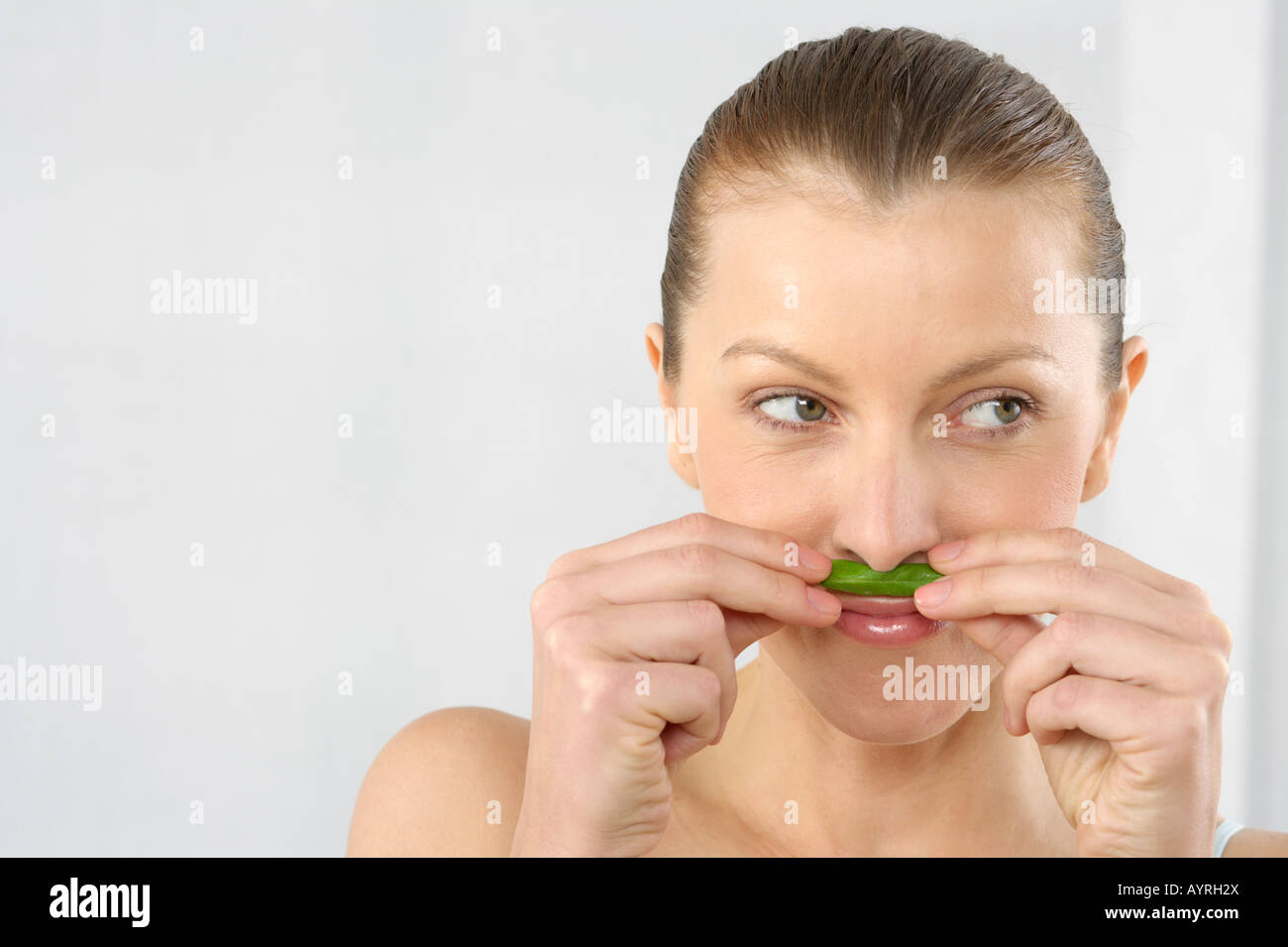 Mid adult woman smelling a basil leaf Stock Photo - Alamy