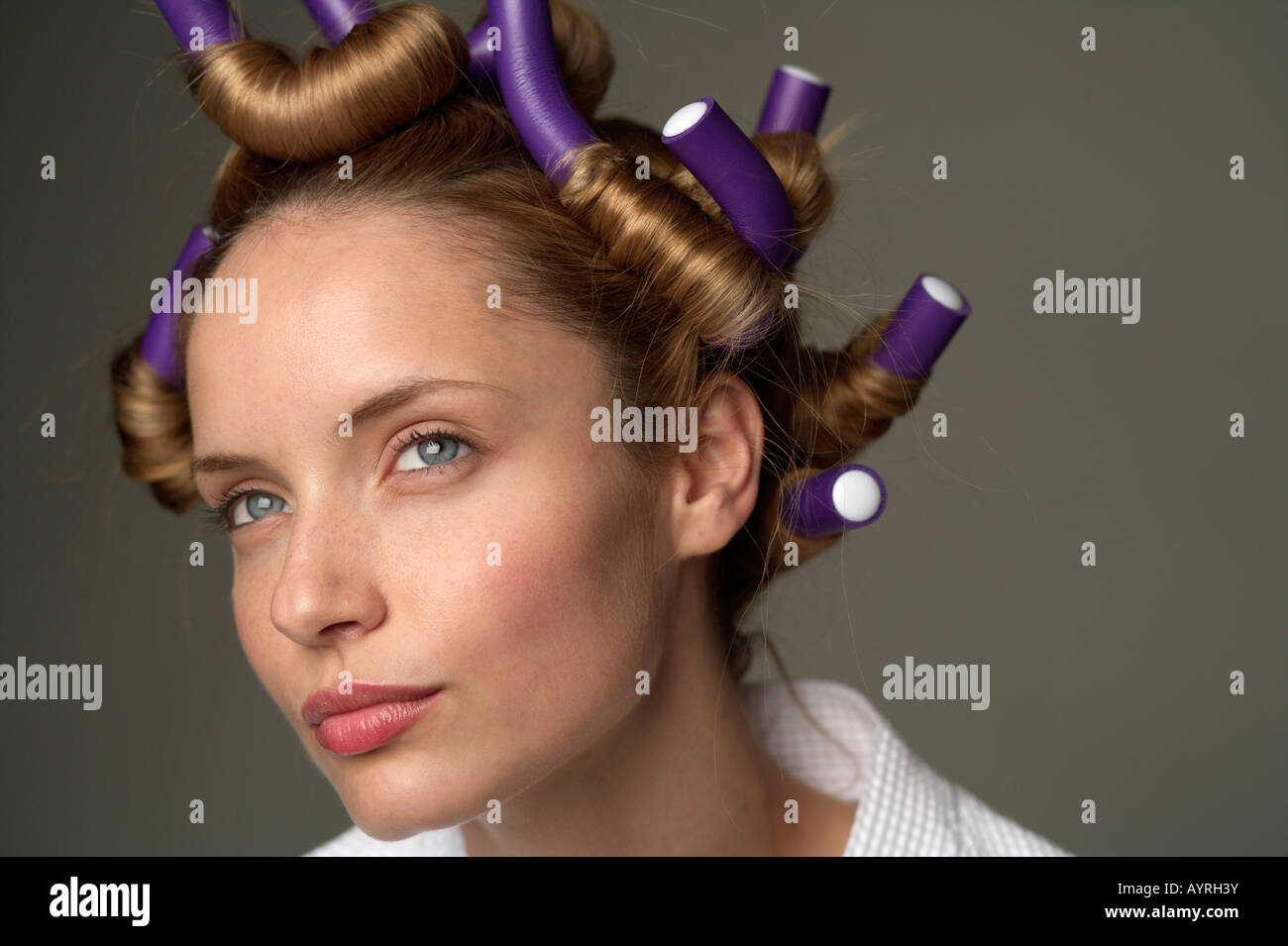 Young woman with curlers in hair Stock Photo - Alamy
