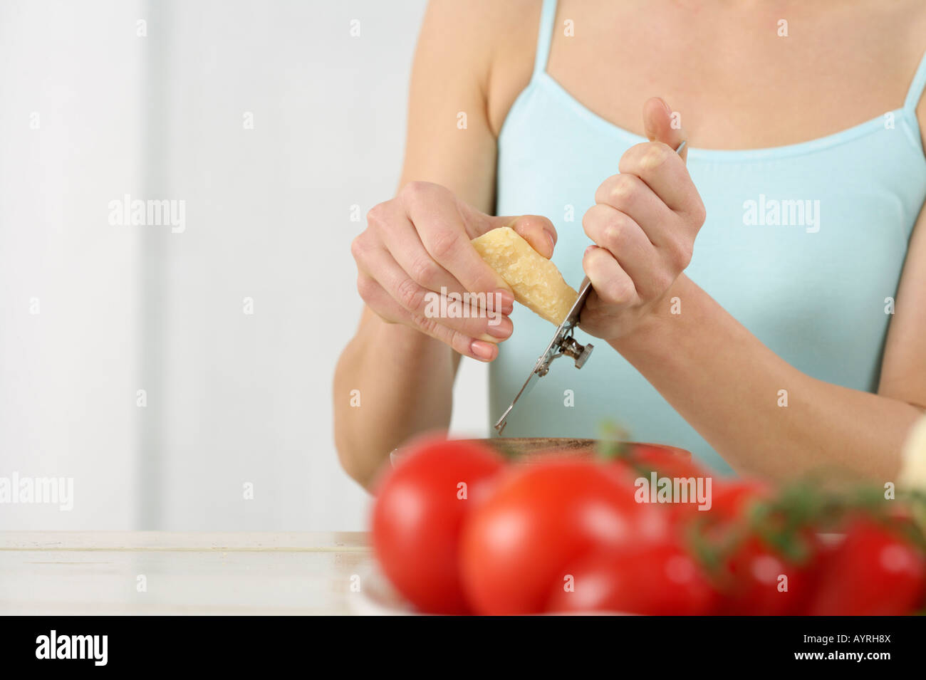 Woman grating parmesan cheese Stock Photo - Alamy