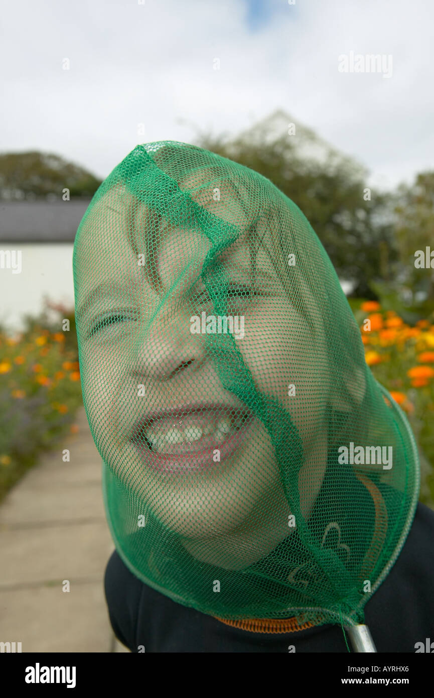 Young boy having fun head in fish net Stock Photo - Alamy