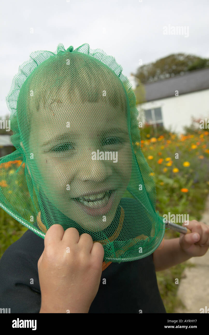 Young boy having fun head in fish net Stock Photo - Alamy