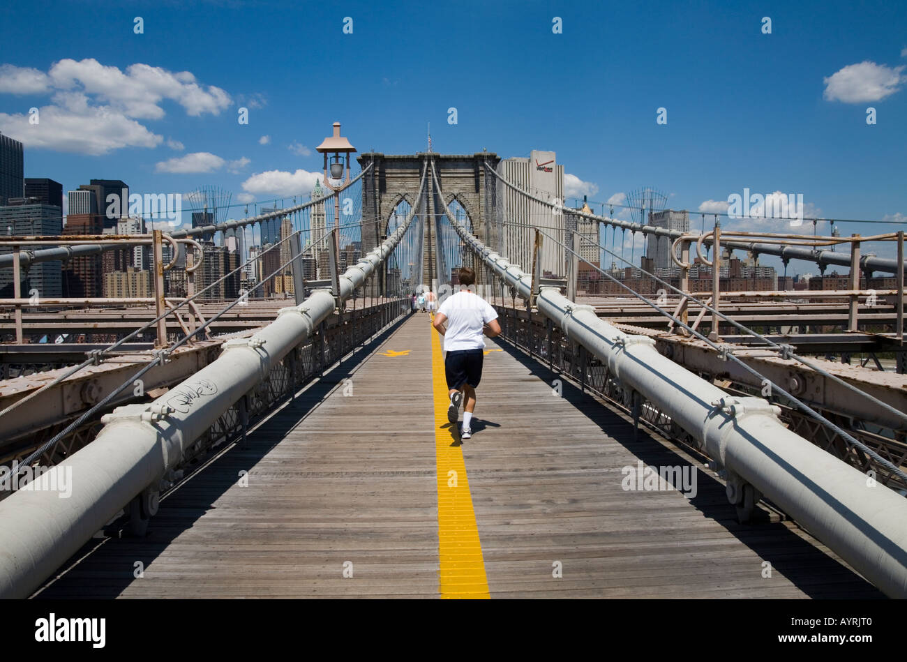 Jogger on the Brooklyn Bridge running towards Manhattan, New York, USA ...