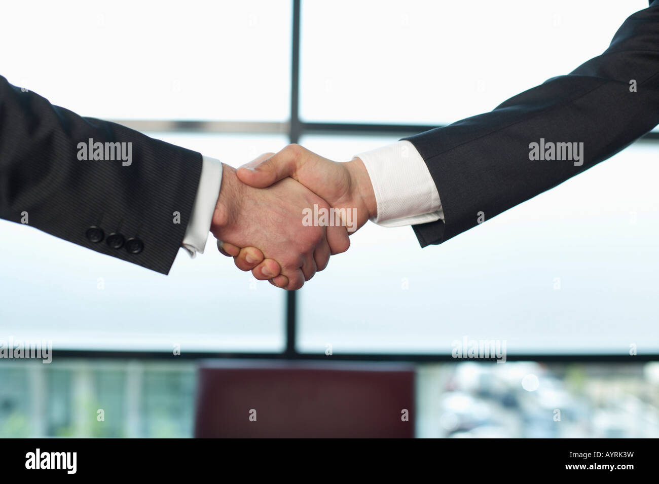 Two businessmen shaking hands Stock Photo - Alamy