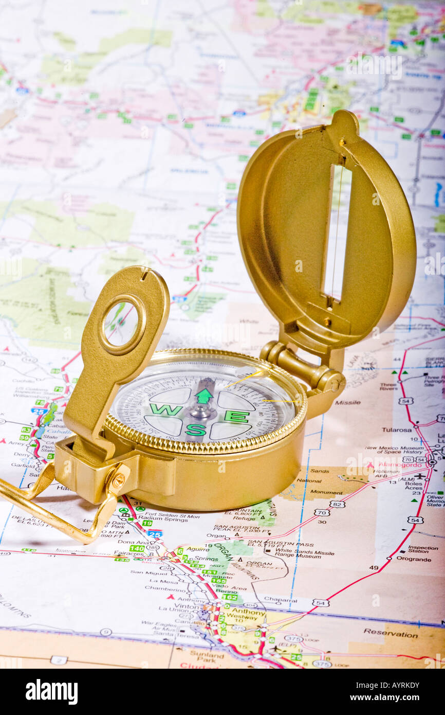 Gold colored compass on a topographic map Stock Photo - Alamy