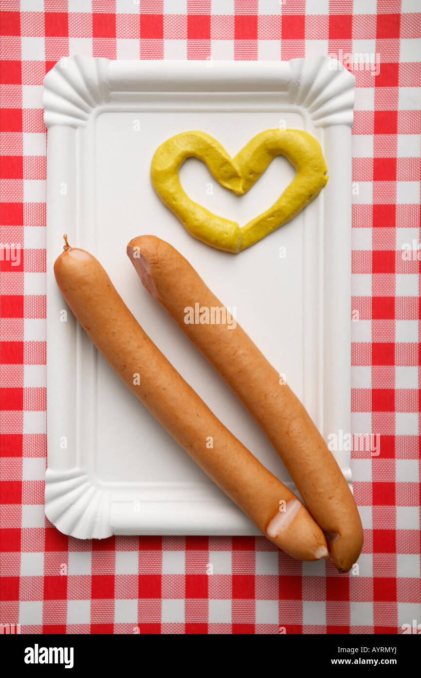 Two wieners with heart-shaped mustard Stock Photo - Alamy