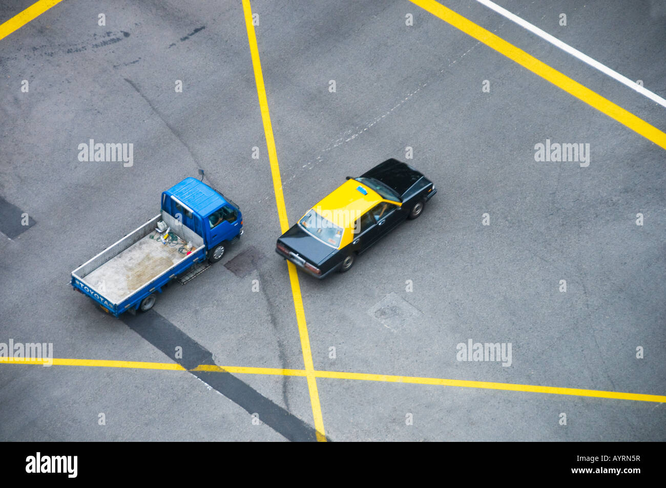 Two vehicles crossing street intersection Stock Photo - Alamy