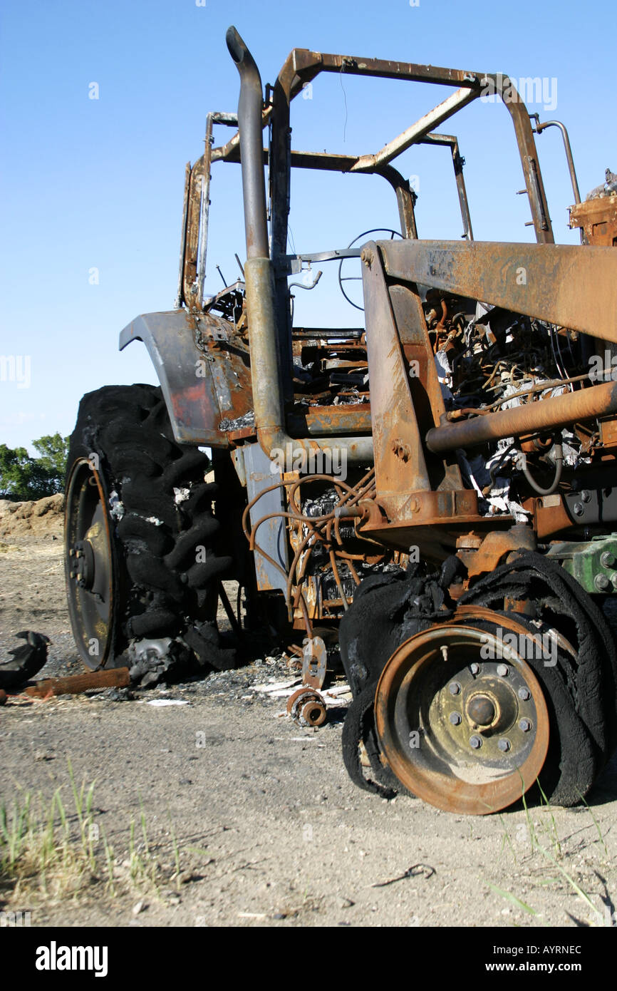 A tractor which has been burned down to the frame Stock Photo - Alamy