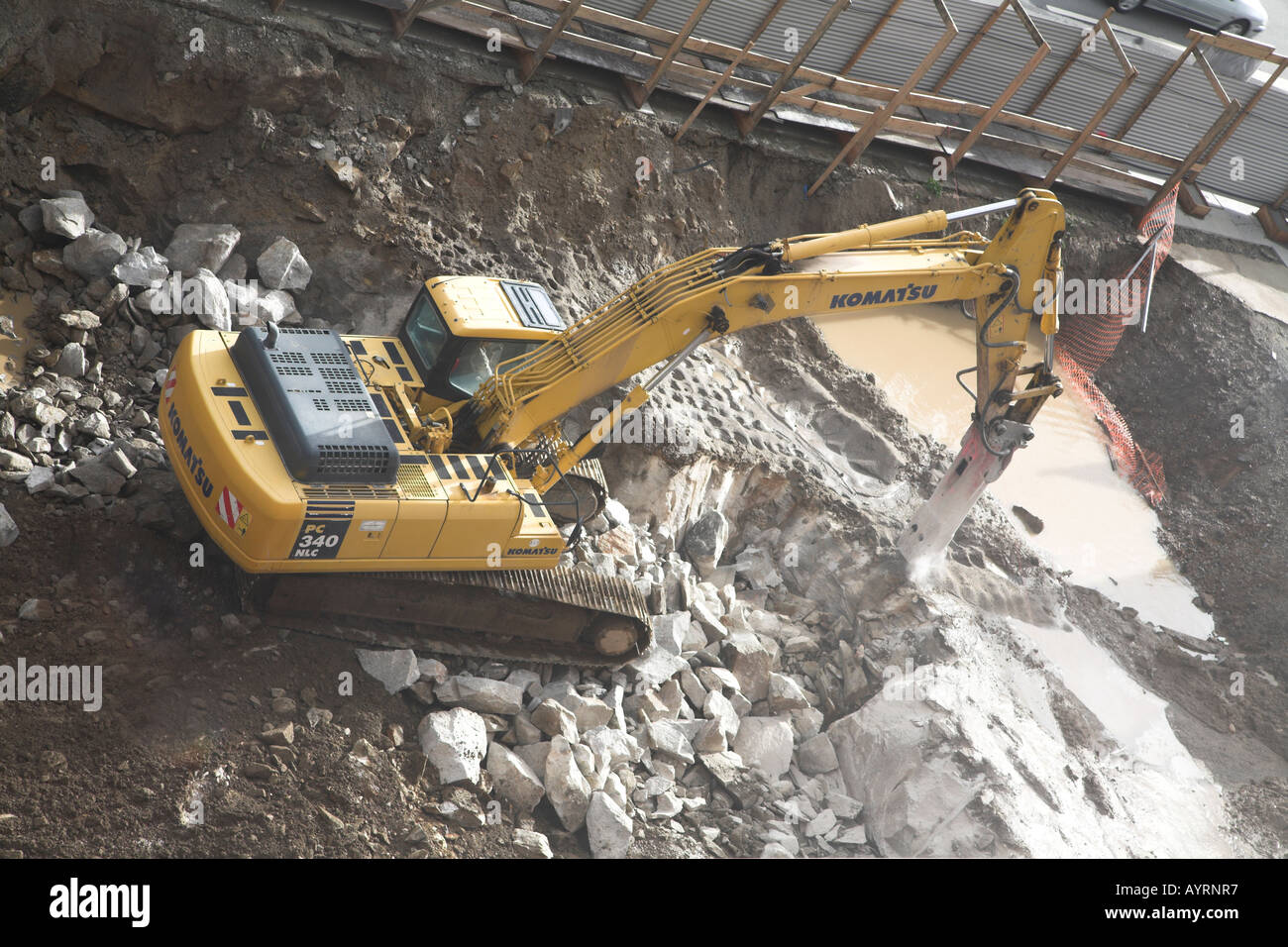 Large yellow machine digging the ground on a construction site Stock ...