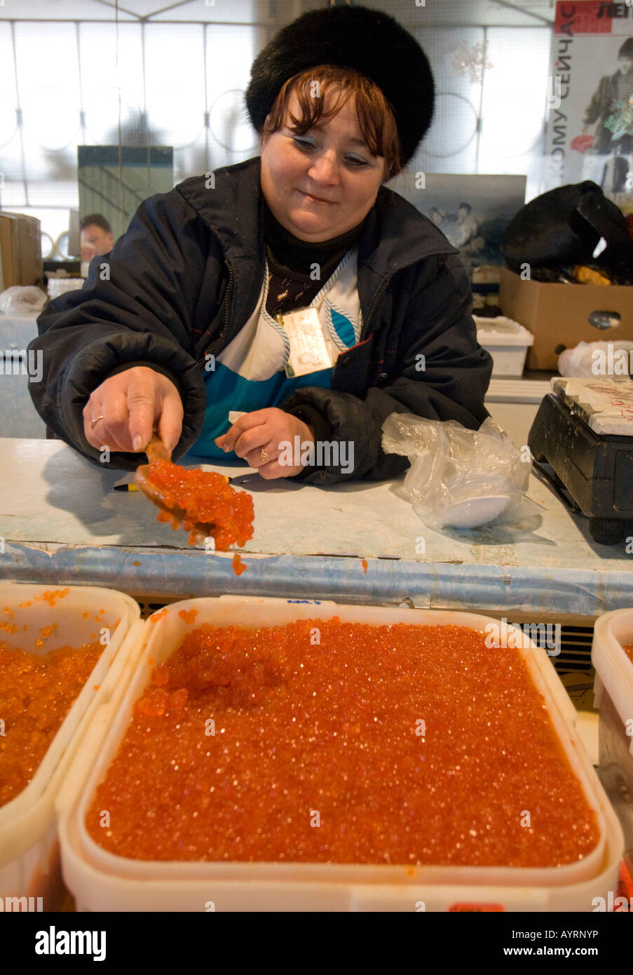 Woman displays fresh salmon caviar at fish market in city of ...