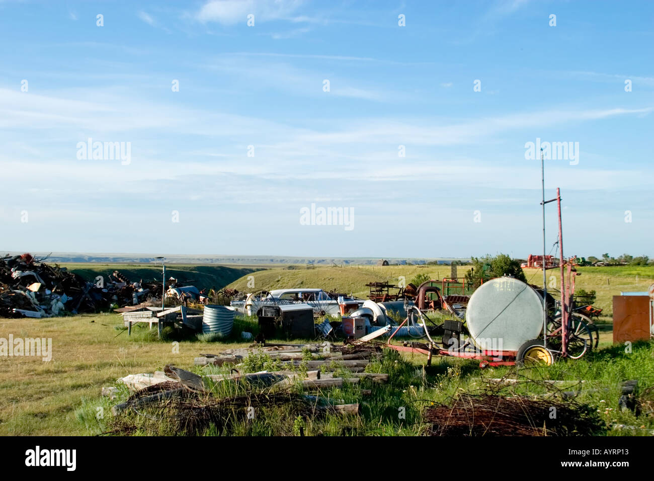 A pile of old rusting metal and old equipment on the prairie Stock ...