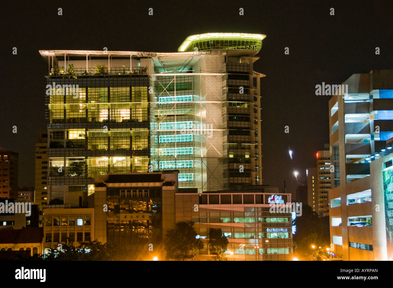 City view of National Public library at night in downtown Singapore ...