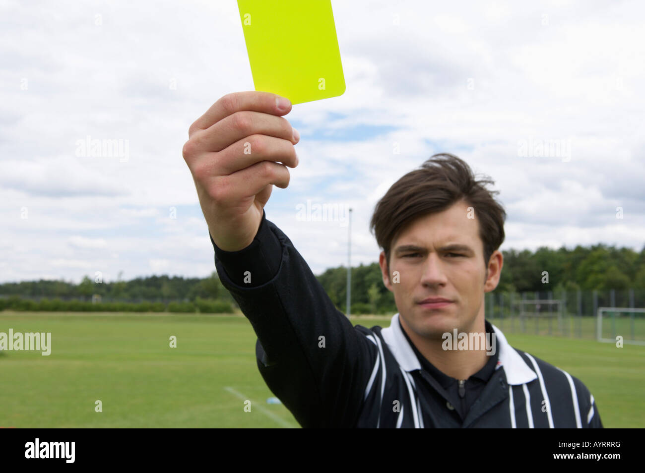 Referee with yellow card hi-res stock photography and images - Alamy