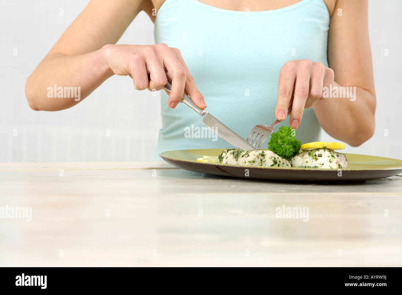 Woman eating fish Stock Photo - Alamy
