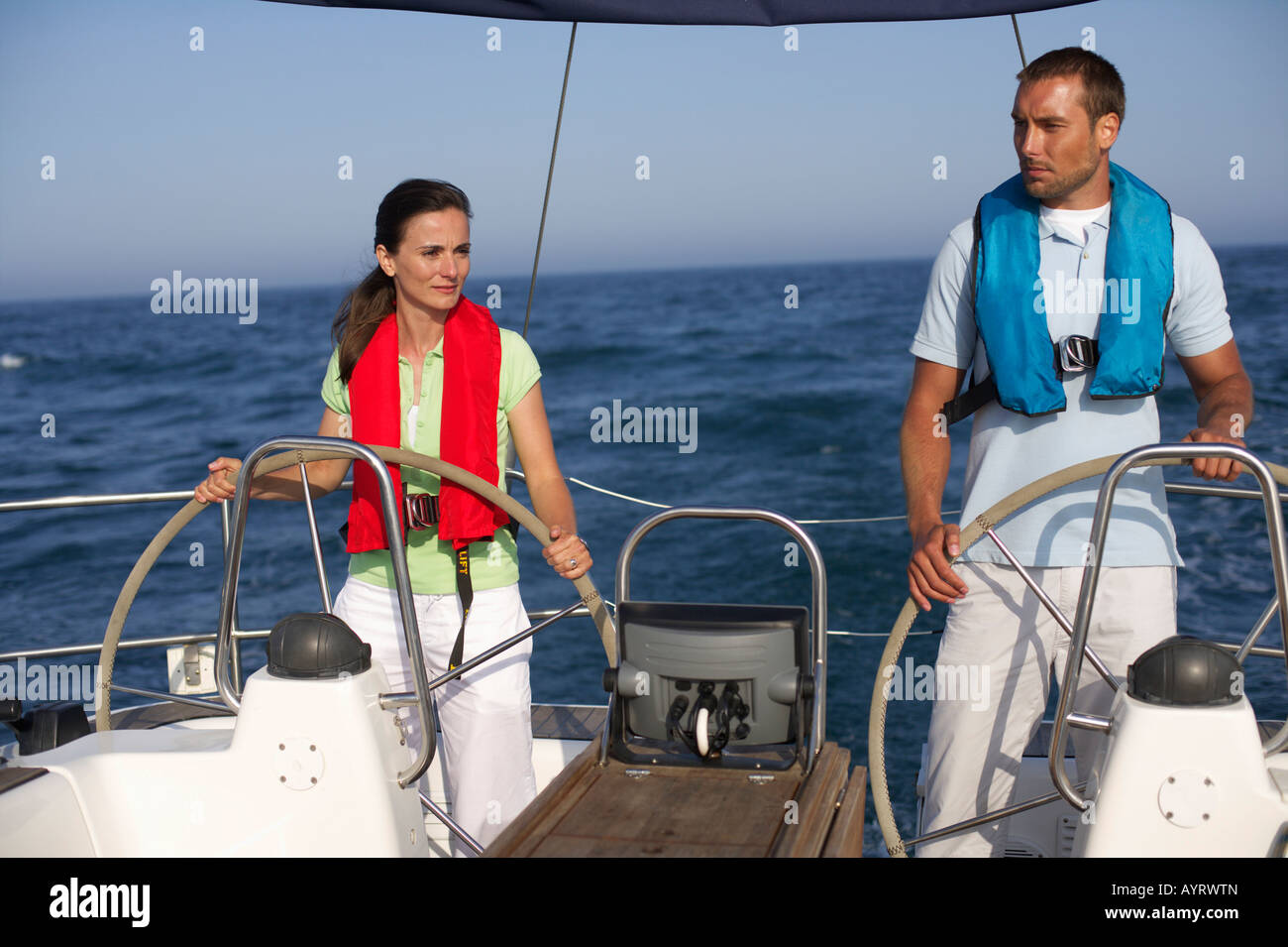 Young woman steering yacht hi-res stock photography and images - Alamy